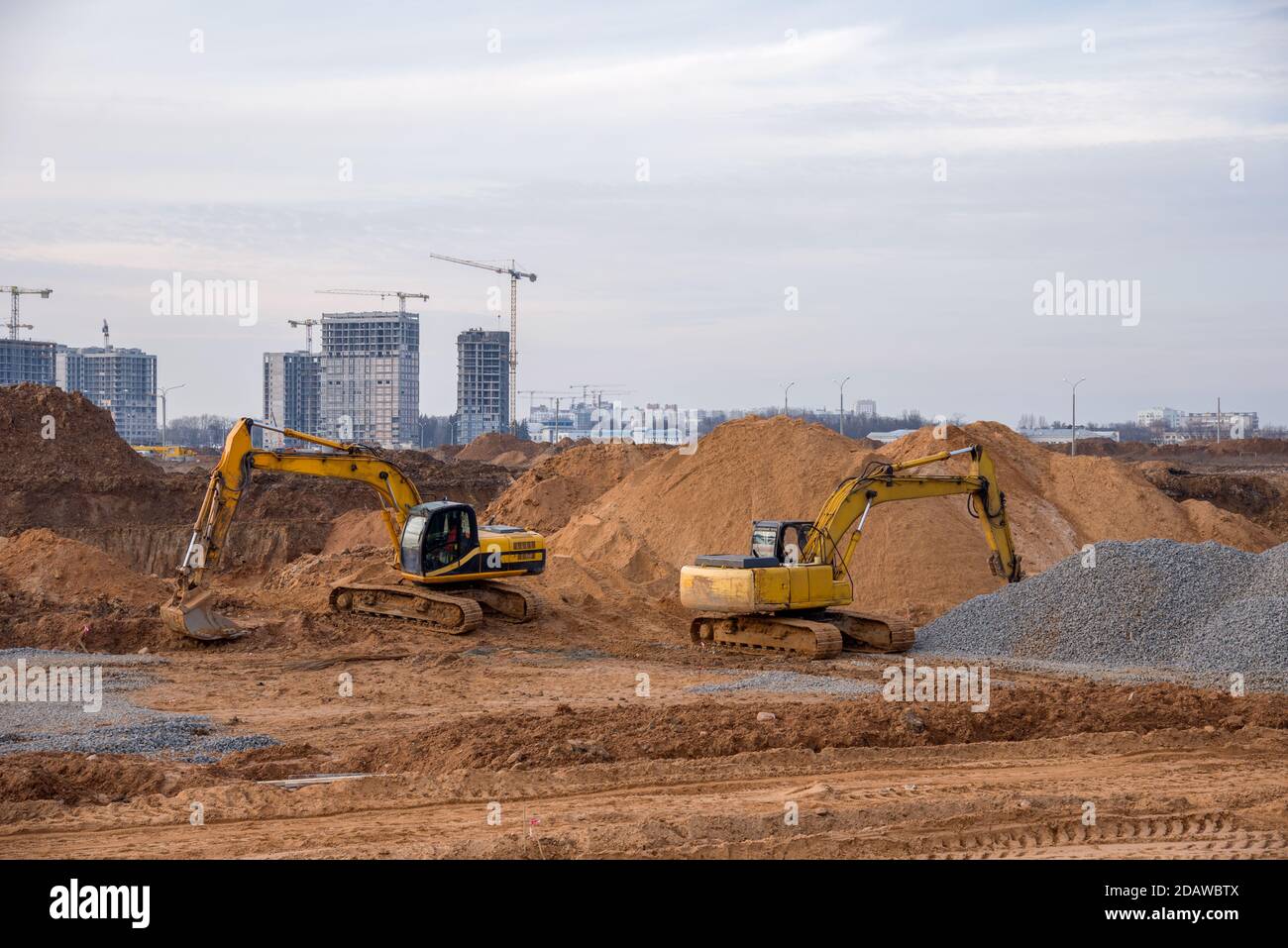 Group of the excavators for dig ground trenching at a construction site ...