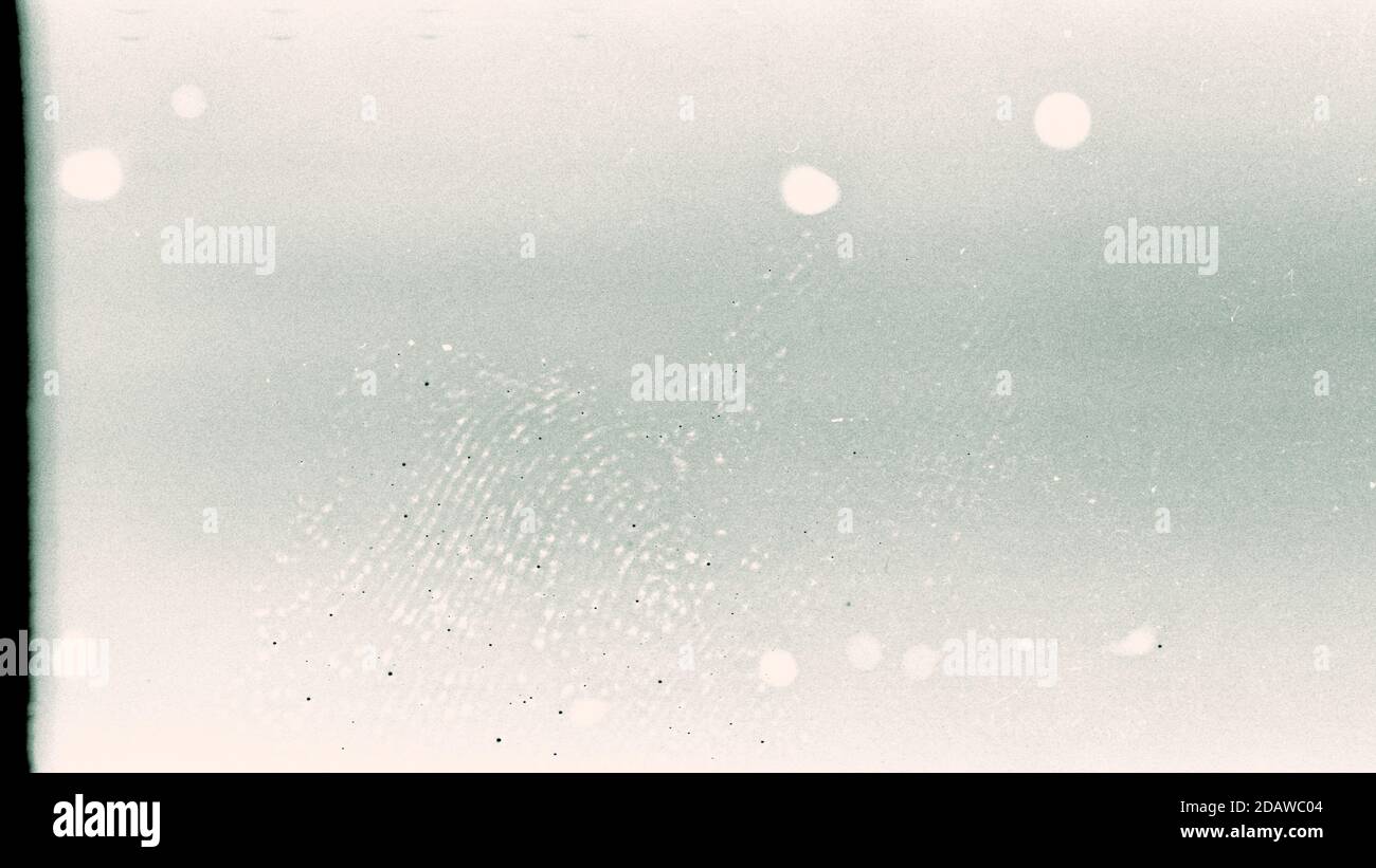 Noisy film frame with heavy scratches, dust and fingerprint. Abstract ...