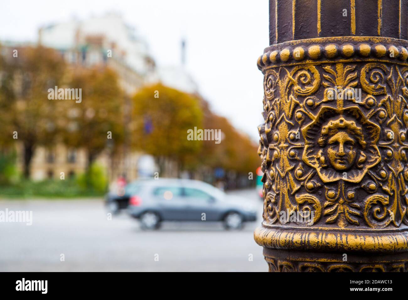 Selective focus shot of a lamp post with golden patterns in Paris ...