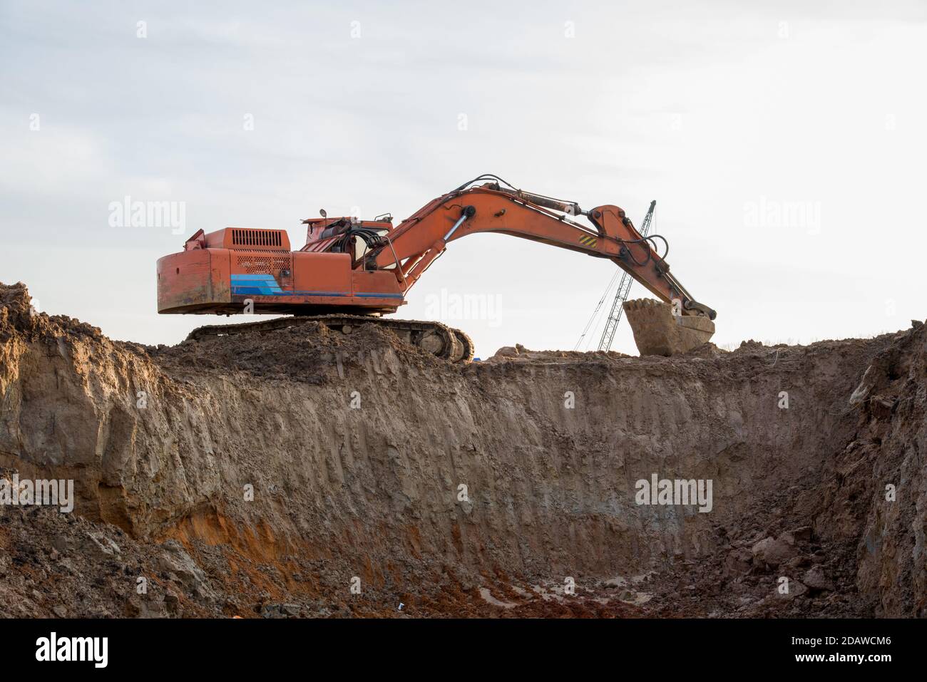 Large excavator working at construction site. Backhoe during earthworks ...