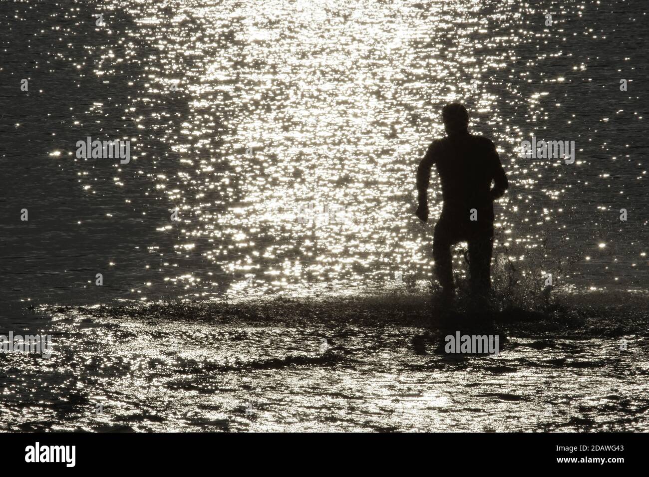 People swim and enjoy the sea during a warm day Stock Photo - Alamy
