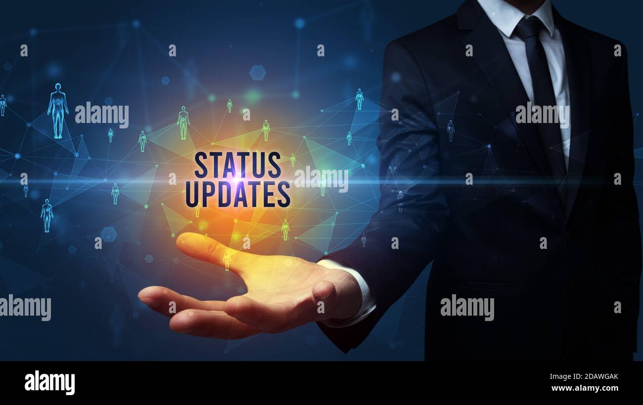 Elegant hand holding STATUS UPDATES inscription, social networking ...