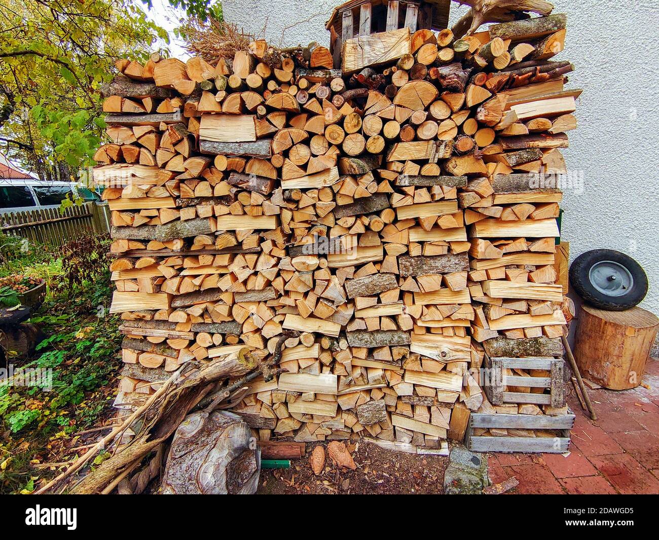 a stack of firewood in front of a house Stock Photo - Alamy