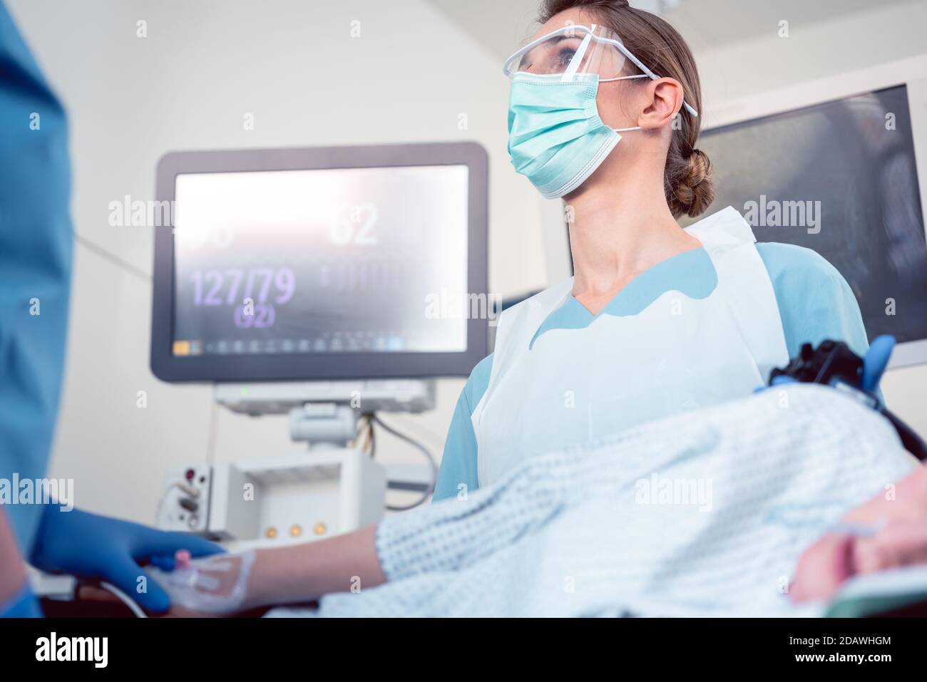 Doctor during colonoscopy in hospital looking at screen Stock Photo - Alamy