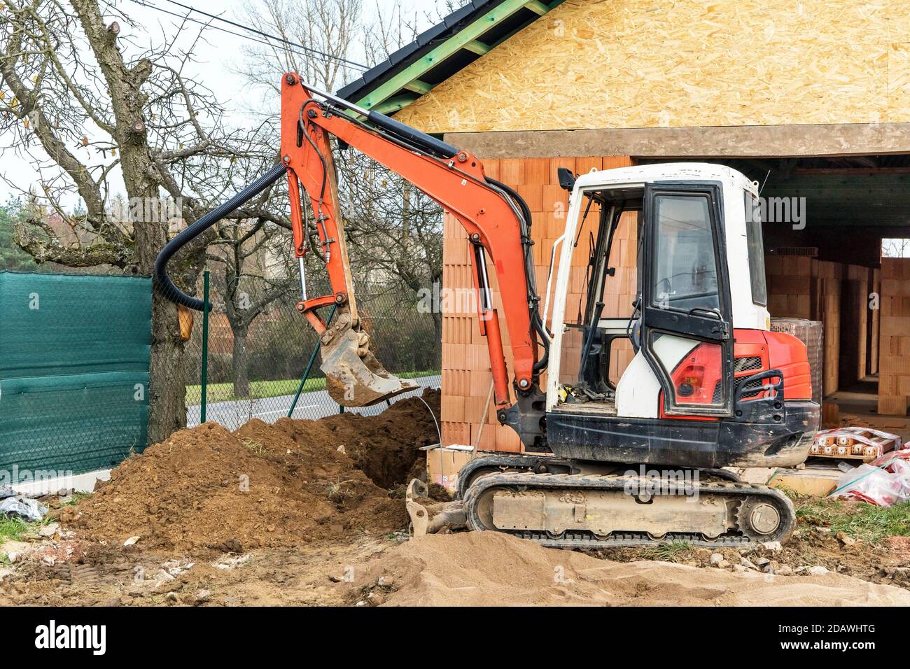 Mini excavator on construction site. Construction of a family house ...
