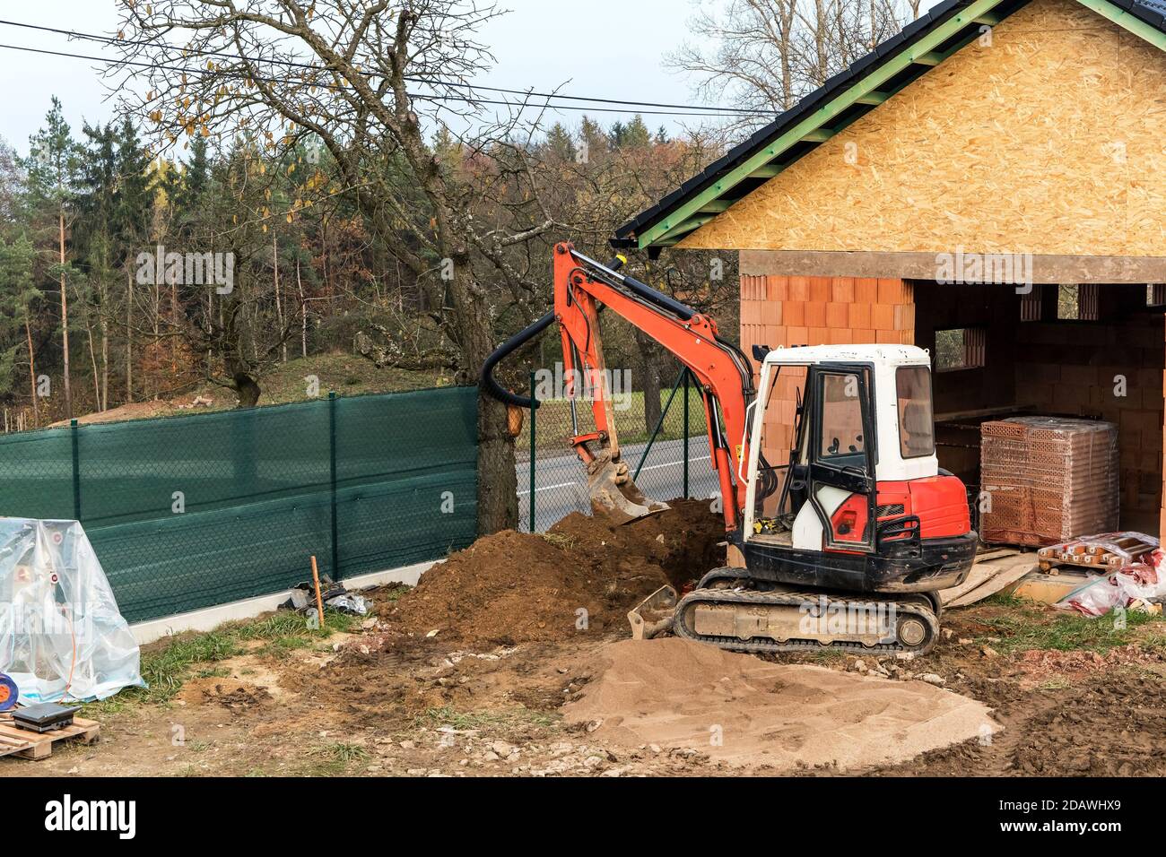 Mini excavator on construction site. Construction of a family house ...