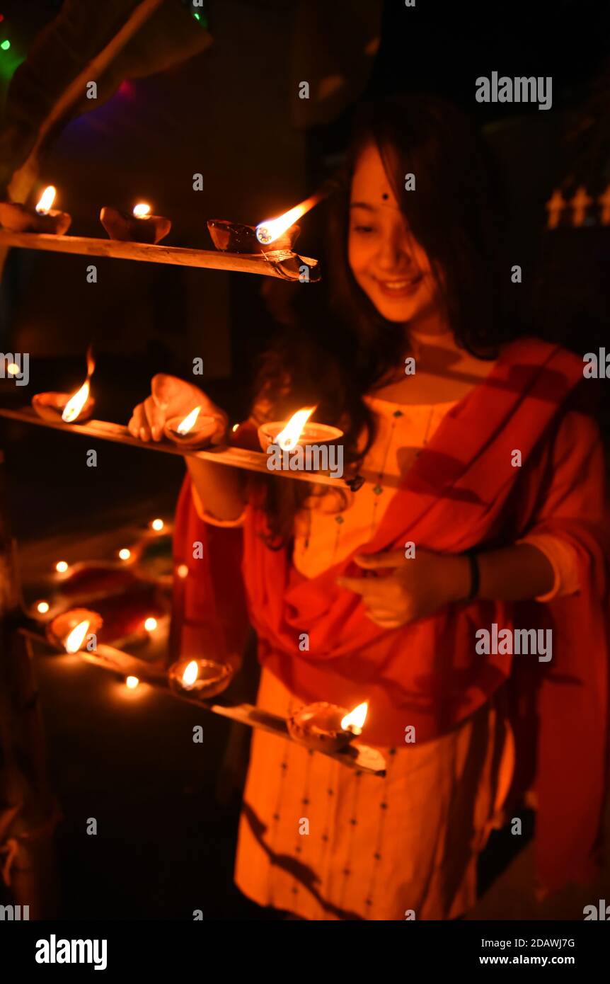 Guwahati, Assam, India. 15th Nov, 2020. Assamese women light earthen ...