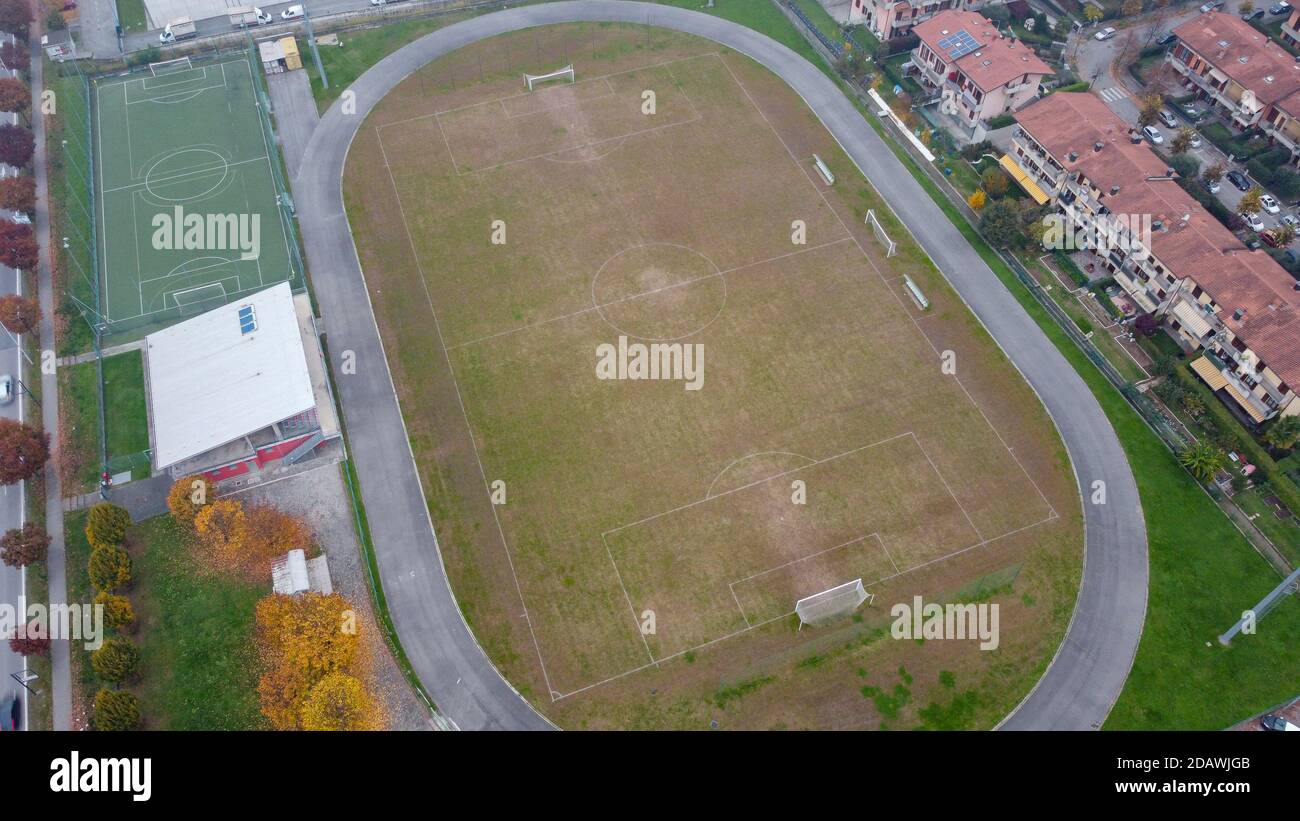 Aerial view of a football field, a drone flies over a city sports ...