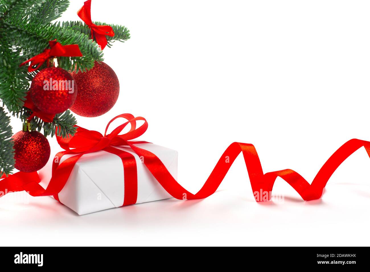 White holiday present gift box with red satin bow and curly ribbon ...