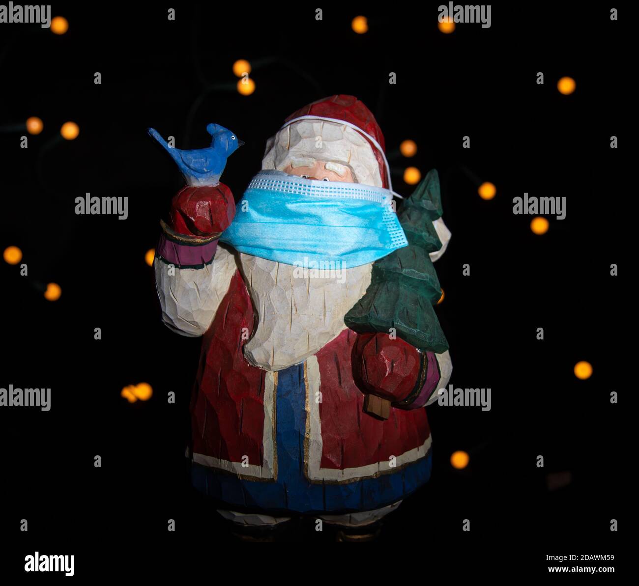 Santa Clause figurine wearing a mouth protection as symbol for impact ...