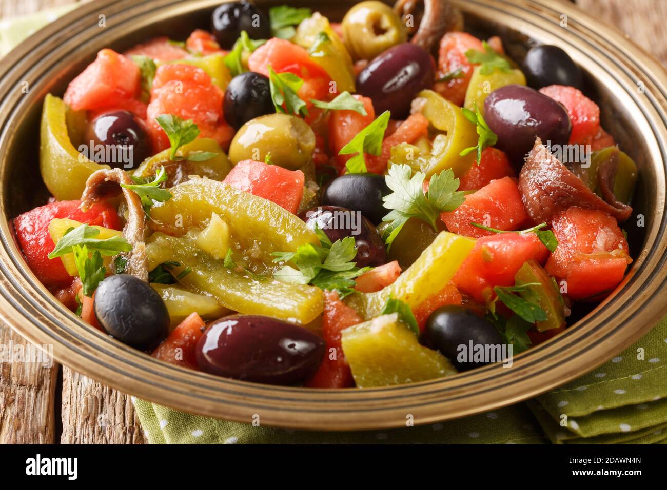 Tomato and green pepper salad Chlada felfel recipe close-up in a bowl ...