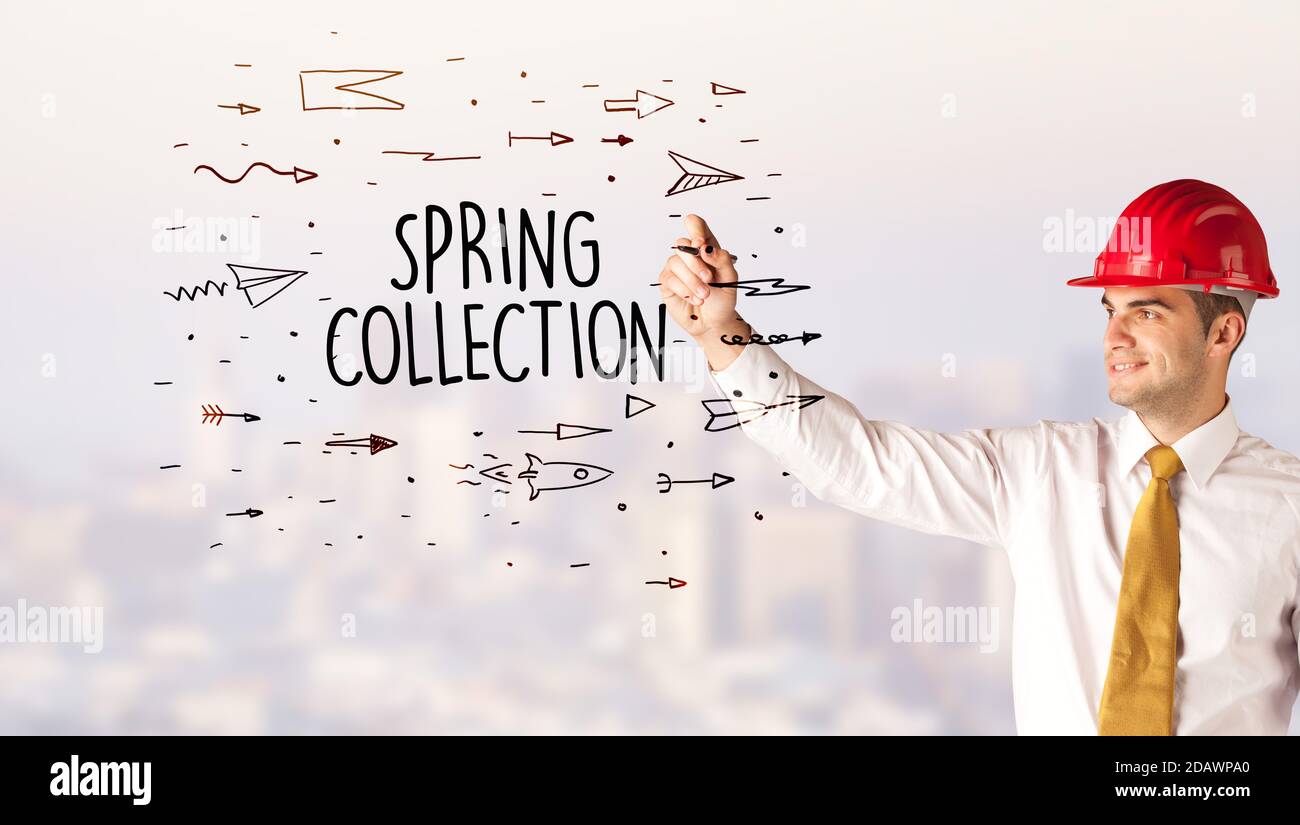 Handsome businessman with helmet drawing SPRING COLLECTION inscription ...