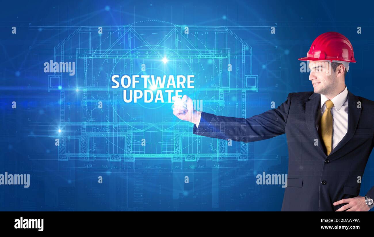 Handsome architect with helmet drawing SOFTWARE UPDATE inscription, new ...