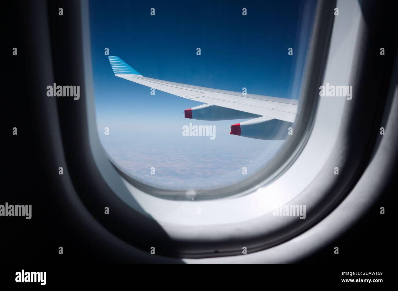 Airplane wing view through windows from place interior. Plane wing ...