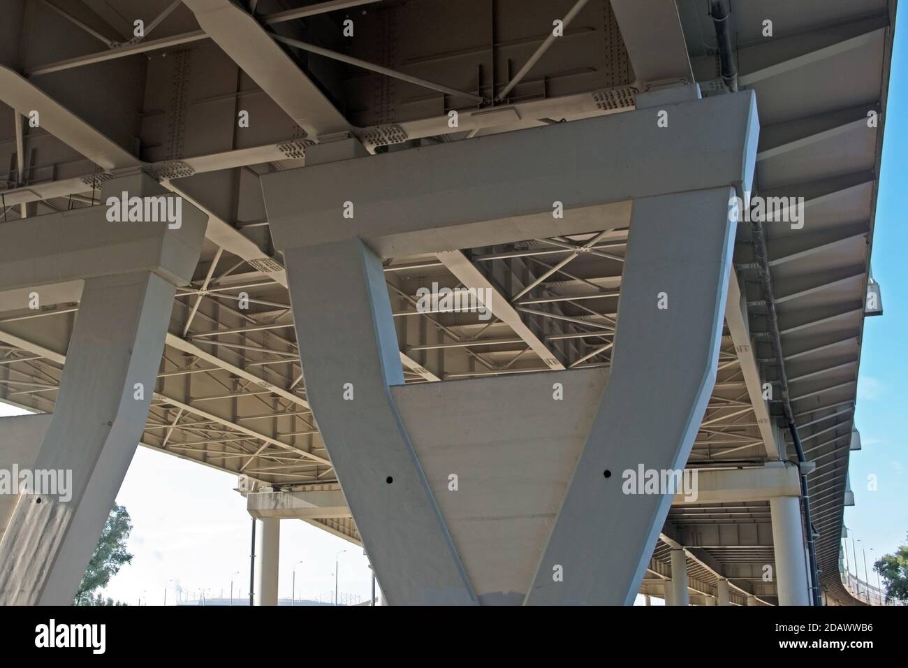 A long, white, curved trestle bridge stretching into perspective ...