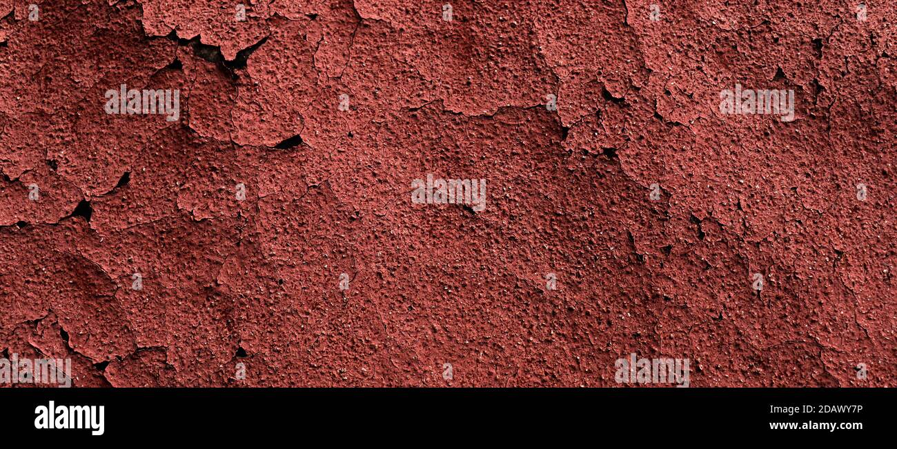 Abstract red cracked and scrached wall texture. Dark wall surface ...