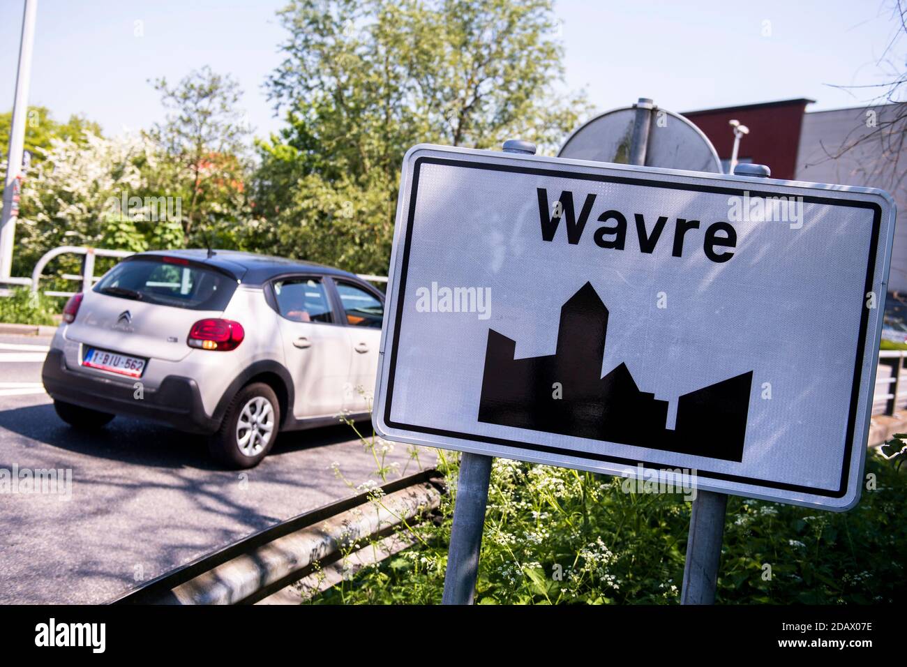 Illustration shows the name of the Wavre municipality on a road sign ...