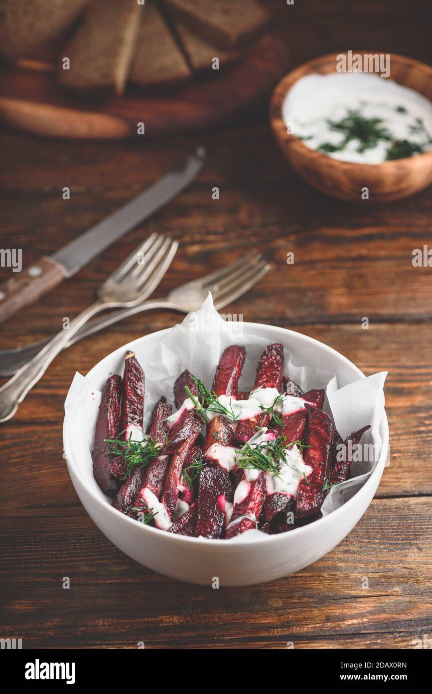 Baked beet fries with greek yogurt and dill Stock Photo - Alamy