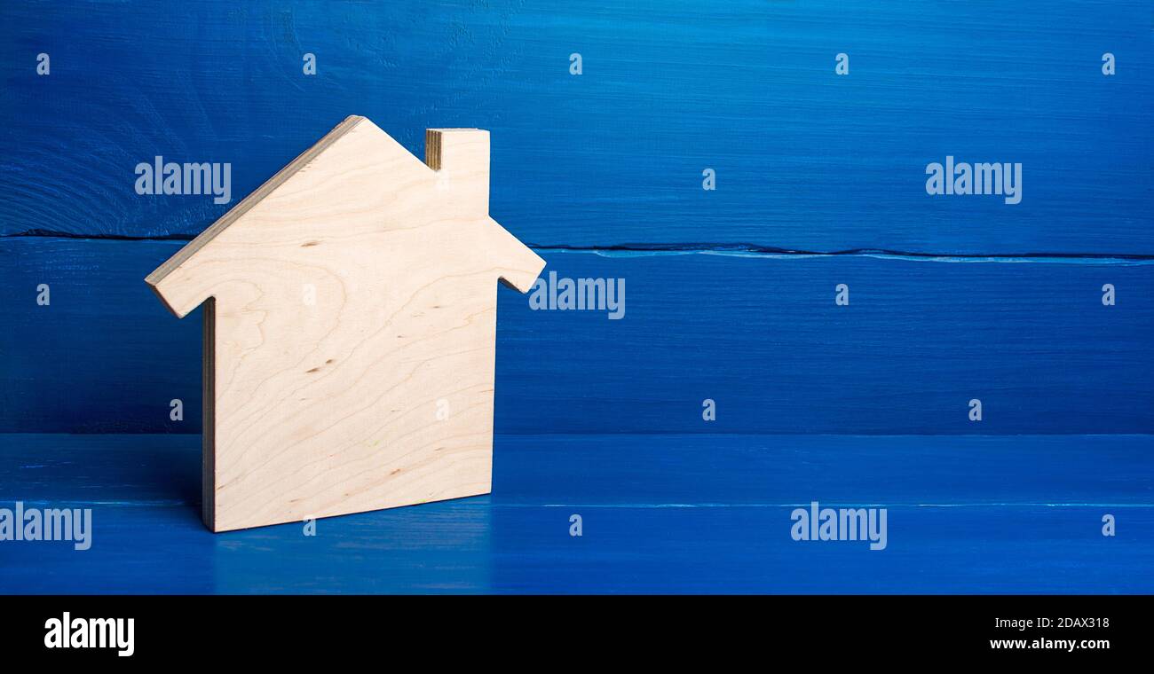 Wooden plane in shape of house figurine on a blue background ...