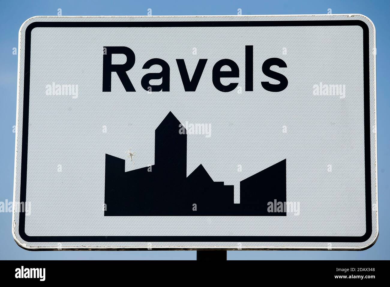 Illustration shows the name of the Ravels municipality on a road sign ...