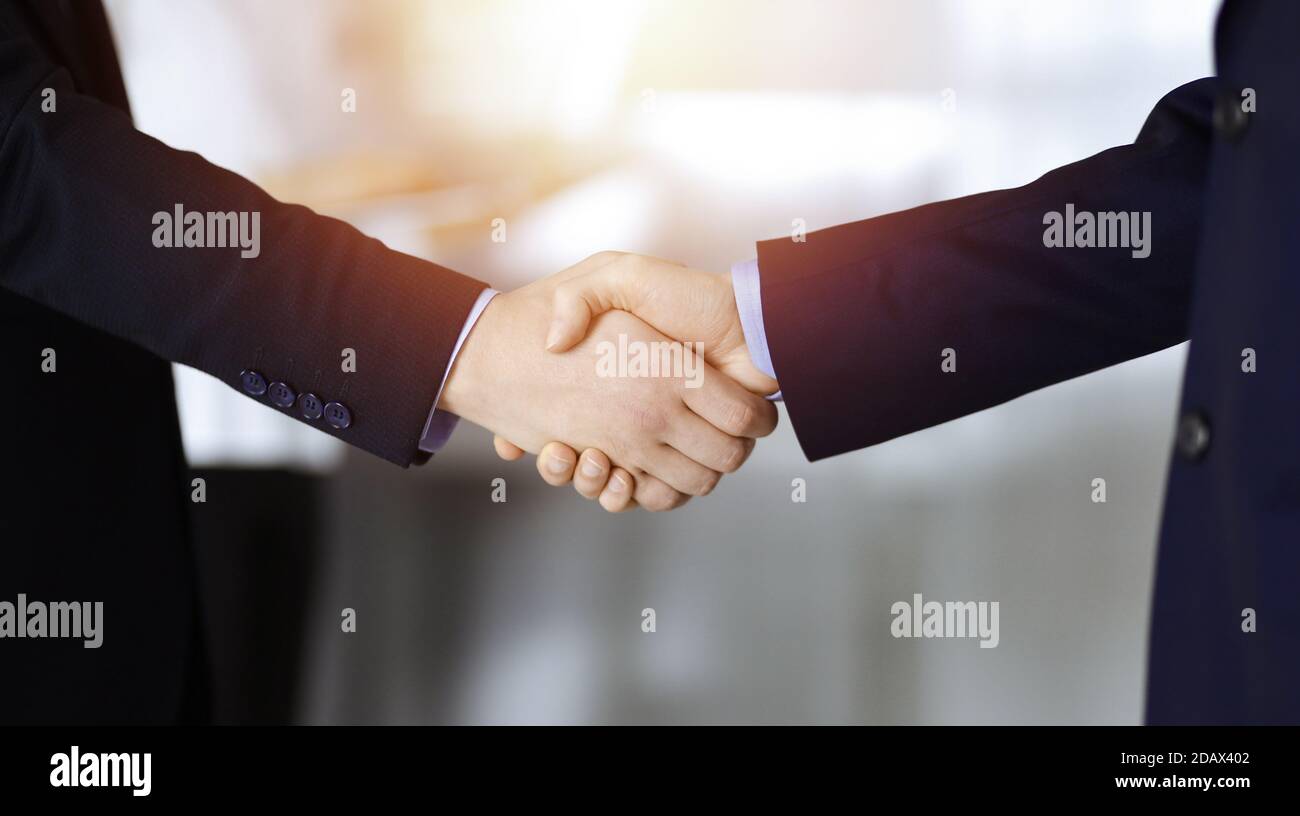 Business people shaking hands at meeting or negotiation, close-up ...