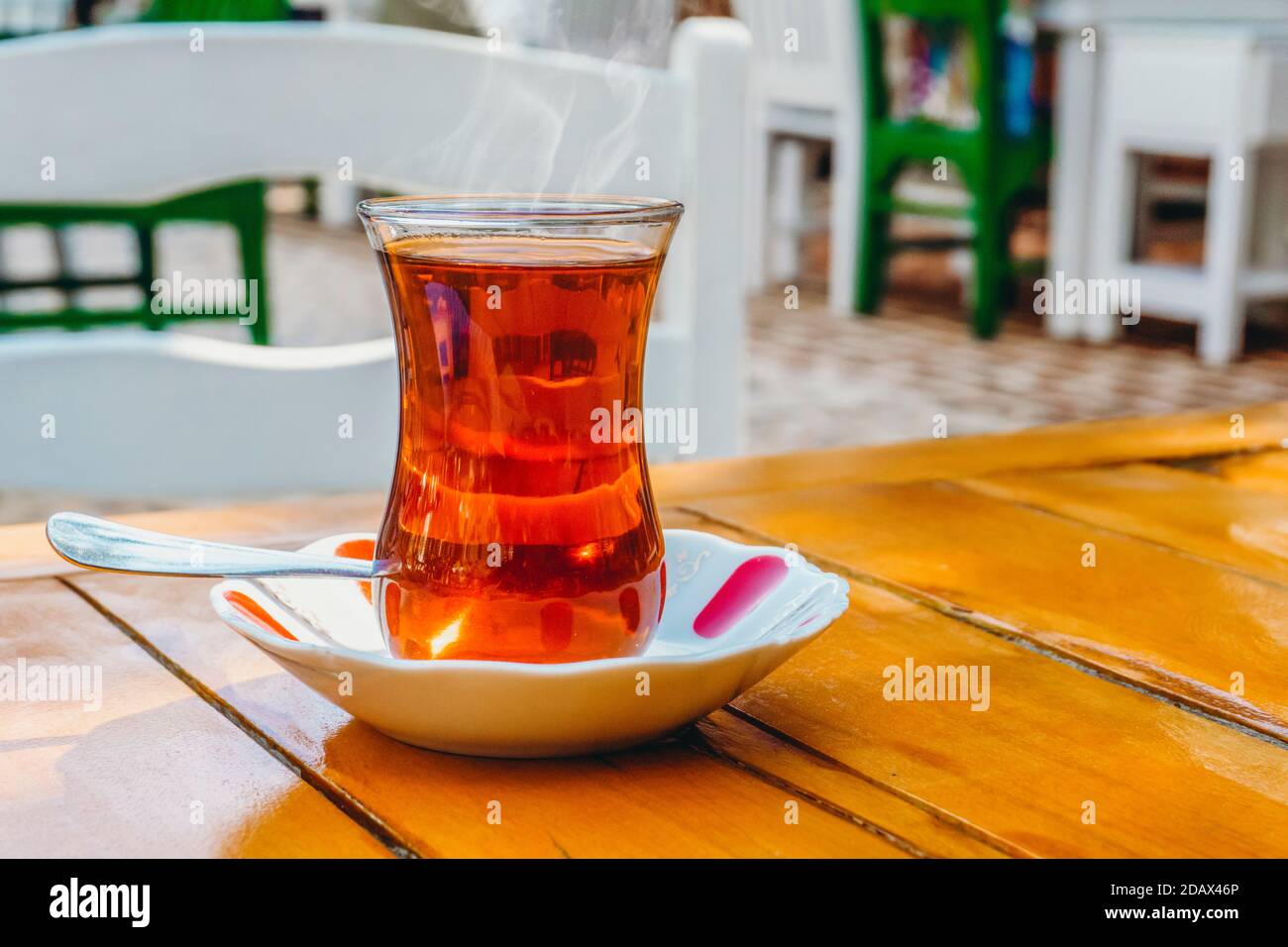 Turkish tea in a glass on the table of a street cafe. Traditional ...