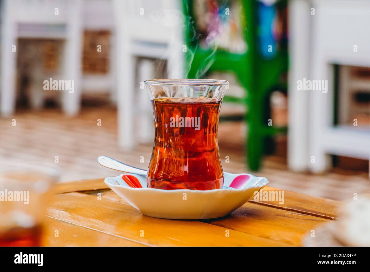 Turkish tea in a glass on the table of a street cafe. Traditional ...