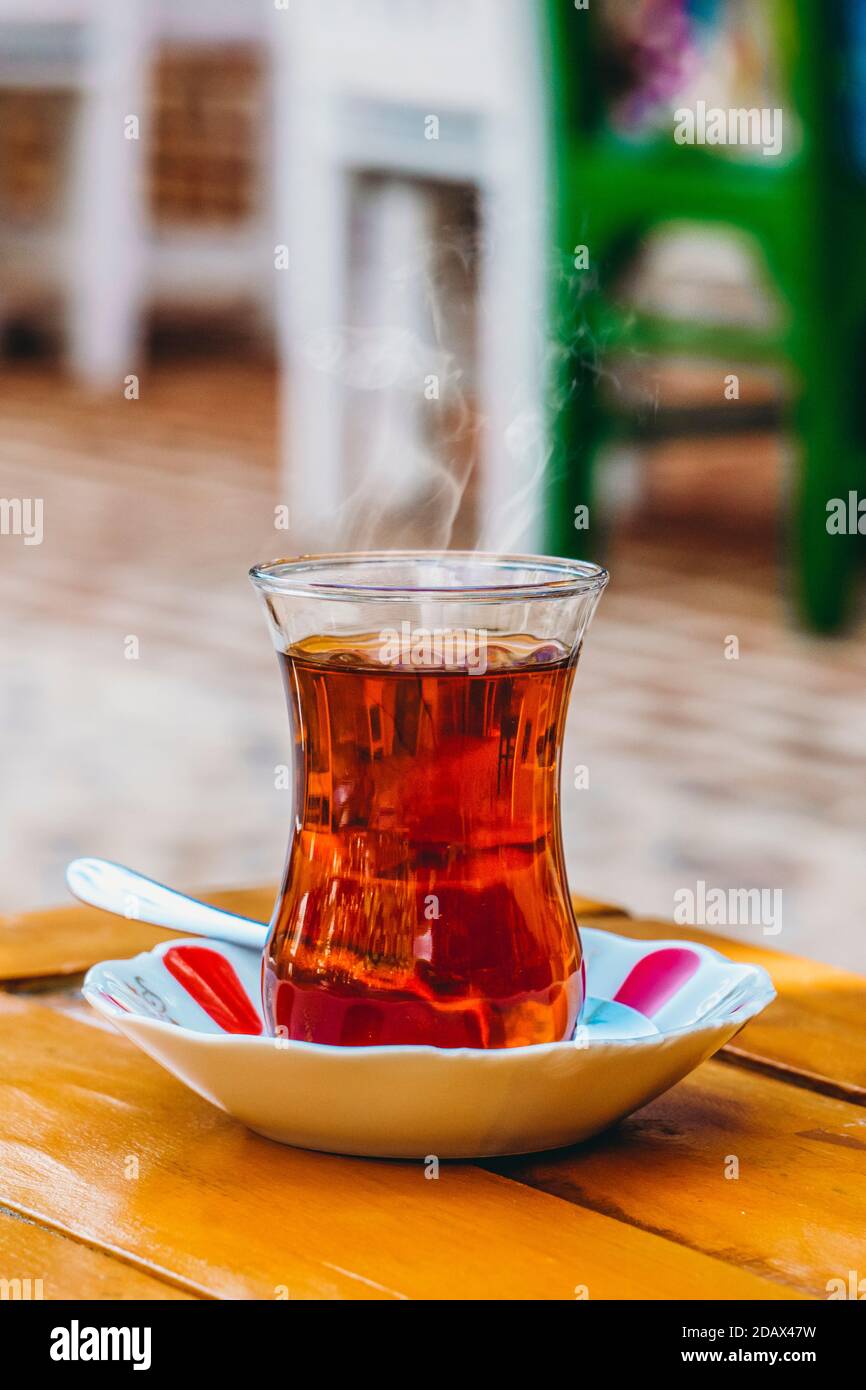Turkish tea in a glass on the table of a street cafe. Traditional ...
