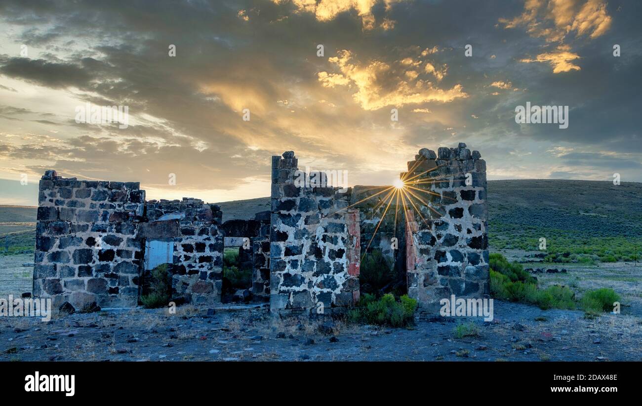 Desert rock structure at sunset with a sun star Stock Photo - Alamy