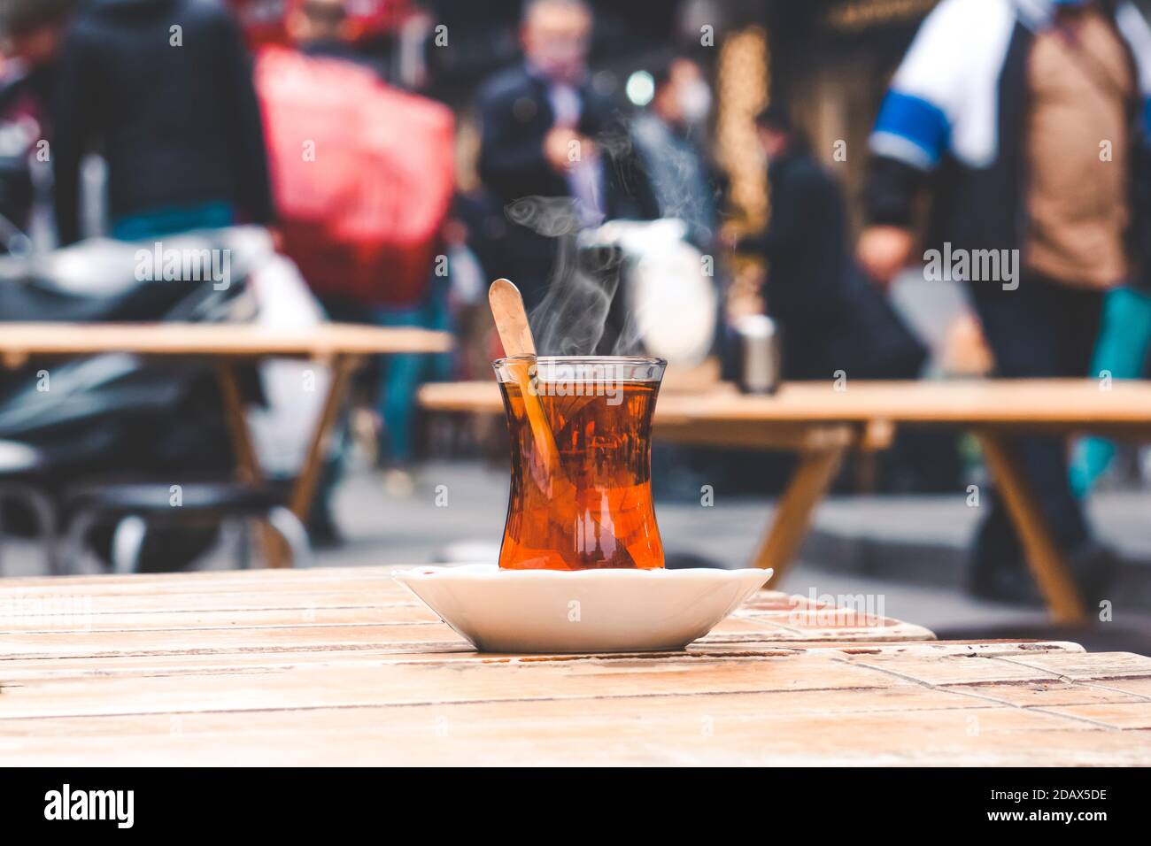 Turkish tea in a glass on the table of a street cafe. Traditional ...