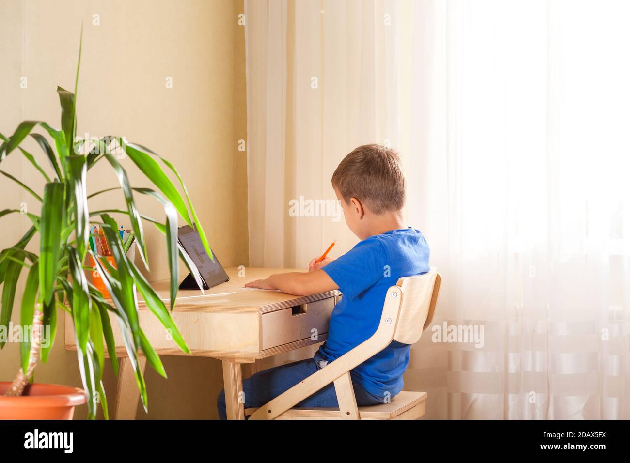 Cute child drawing picure at home. Child using gadgets for study ...