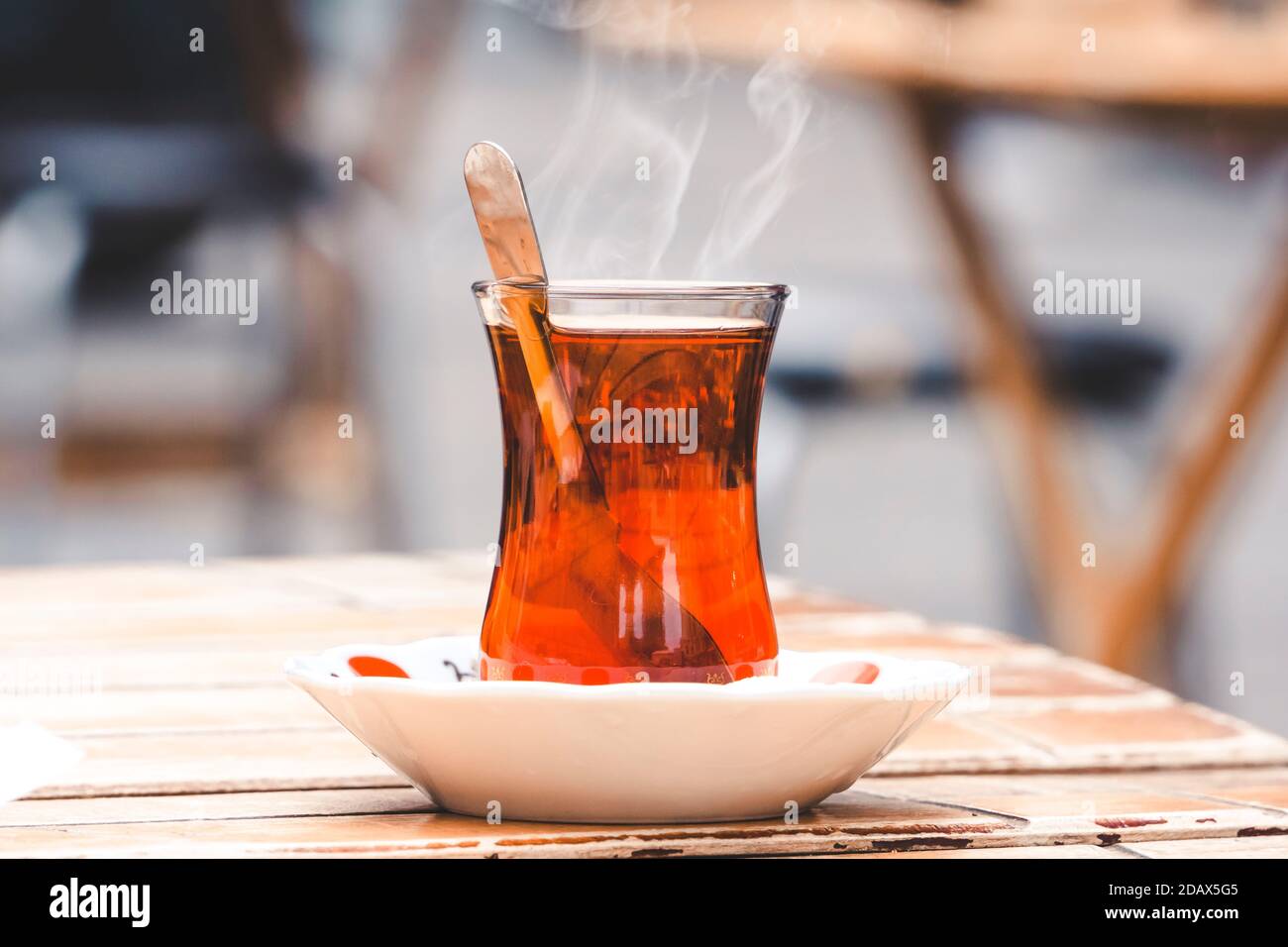 Turkish tea in a glass on the table of a street cafe. Traditional ...