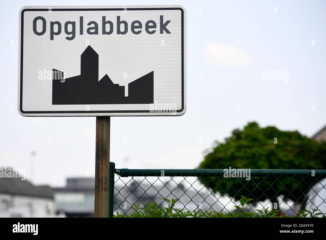 Illustration shows the name of the Opglabbeek municipality on a road ...