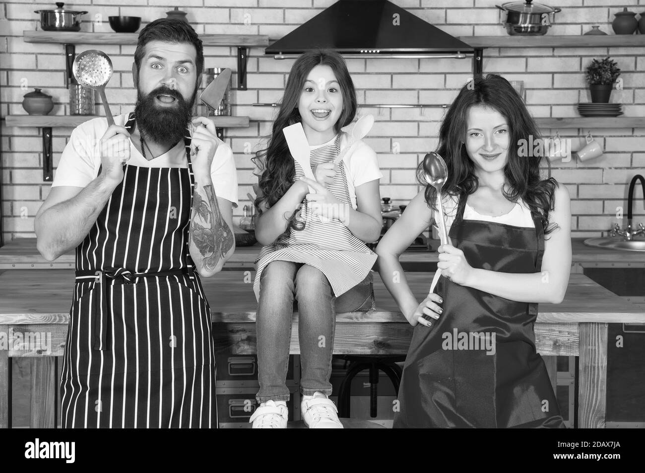 family in kitchen making breakfast together. small girl have fun with ...