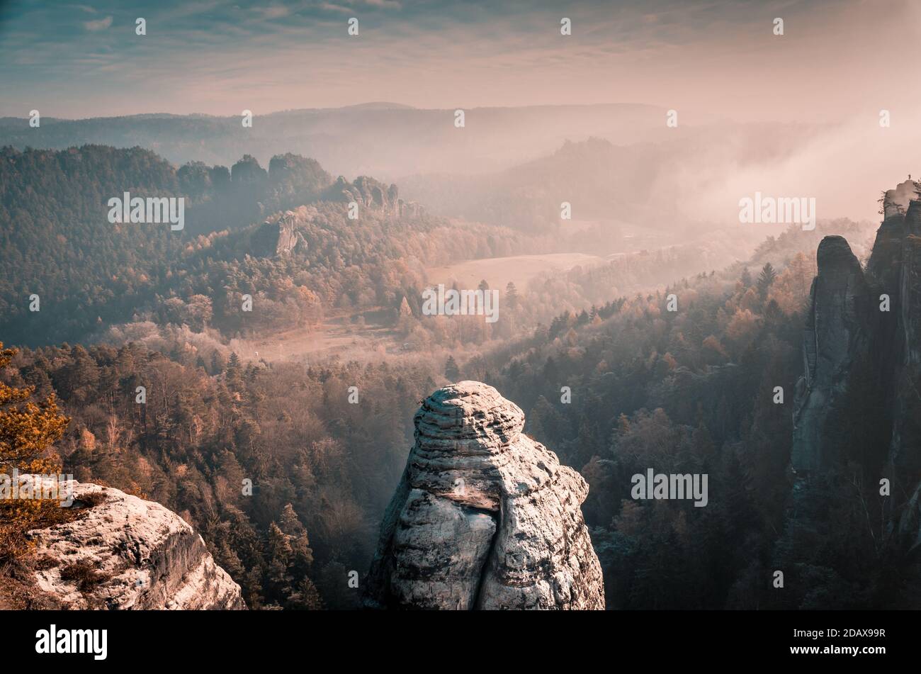 Landscape of rocky outcrops and mountains covered in trees under the ...