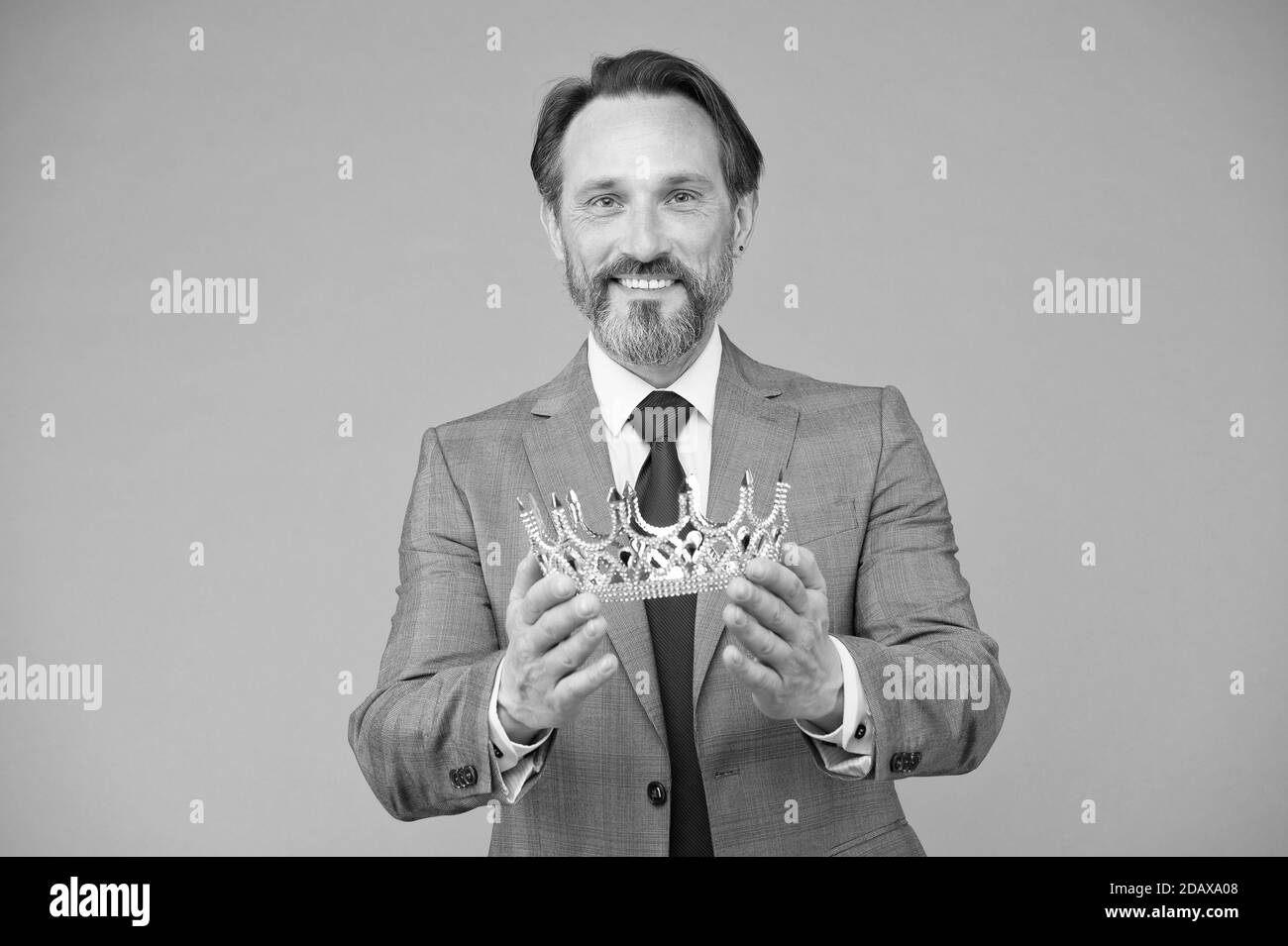 Crown for man who deserves it. Happy businessman hold crown grey ...