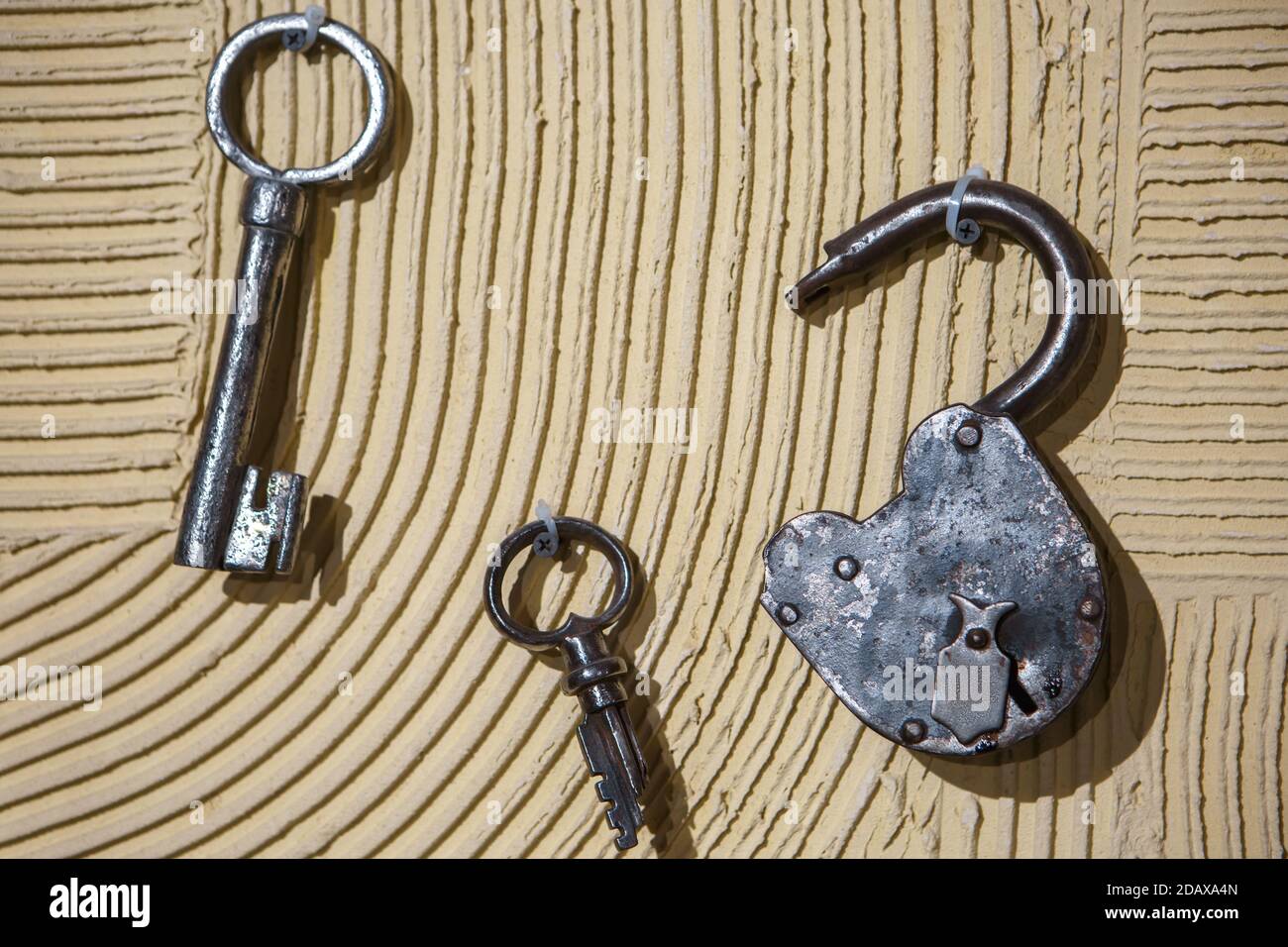 Old barn lock and keys hanging on the wall closeup Stock Photo - Alamy