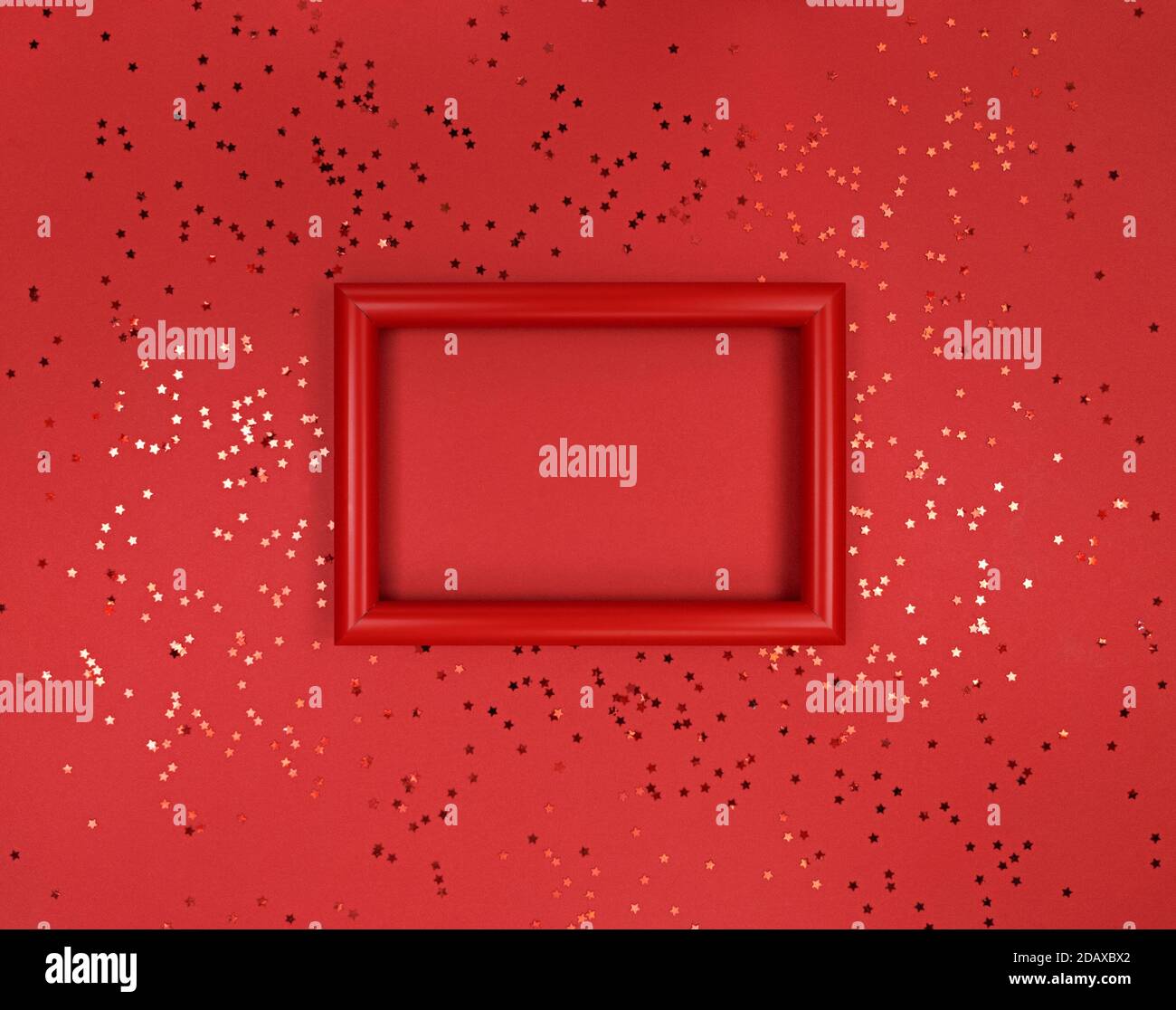 Frame and confetti stars on red background Stock Photo - Alamy