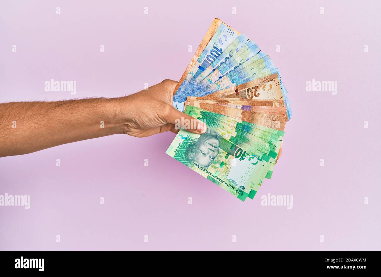 Hand holding south african rand hi-res stock photography and images - Alamy