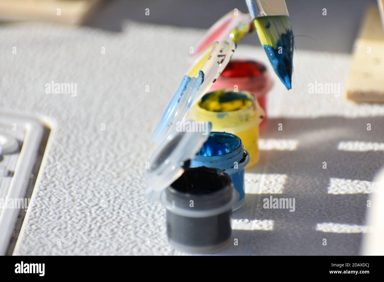 Close up of small craft paint containers with open lids Stock Photo - Alamy