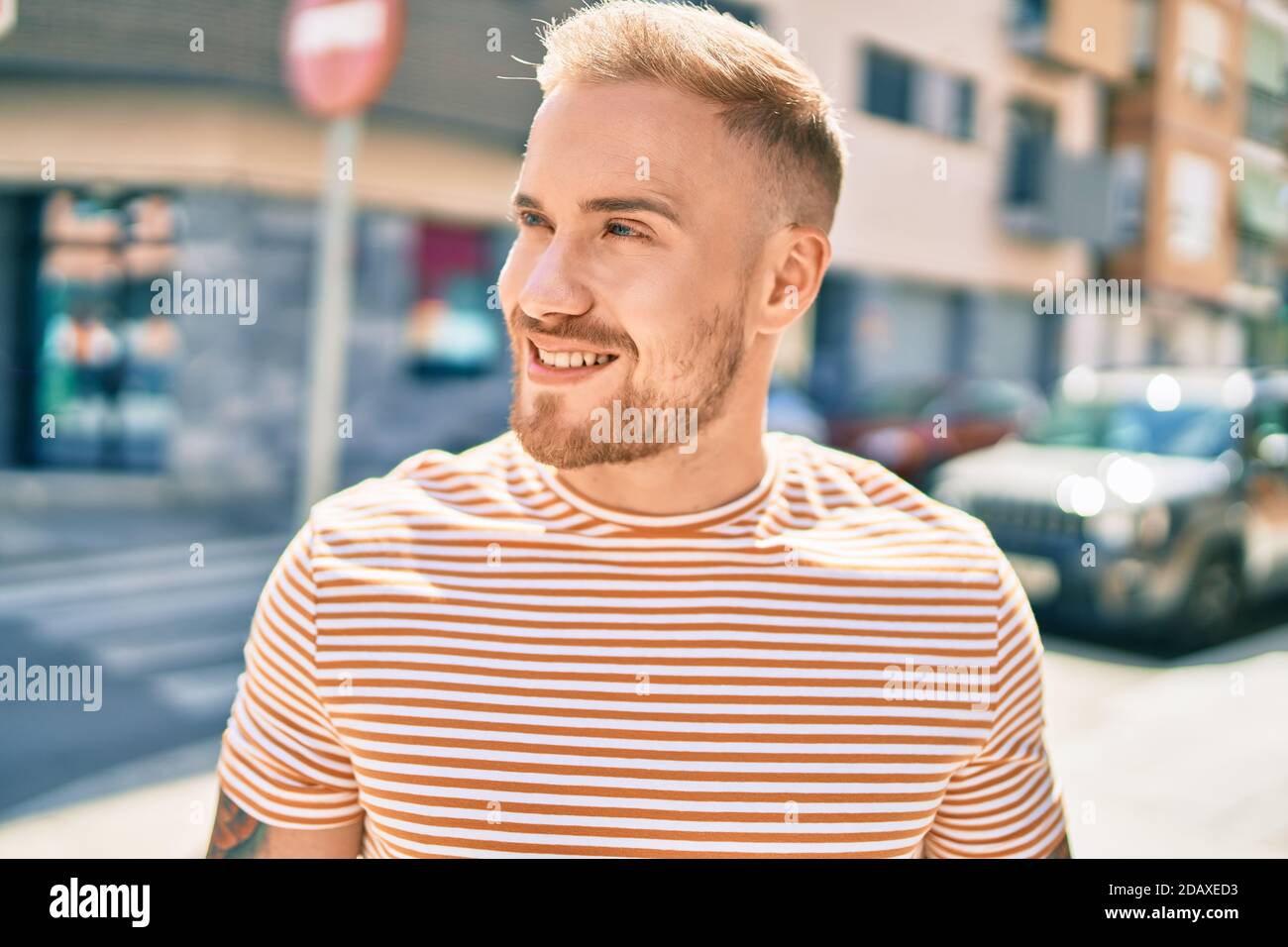 Young irish man smiling happy walking at street of city Stock Photo - Alamy
