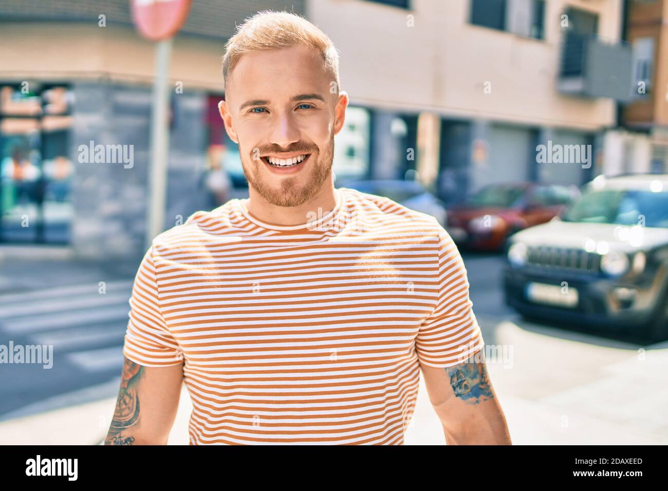 Young irish man smiling happy walking at street of city Stock Photo - Alamy
