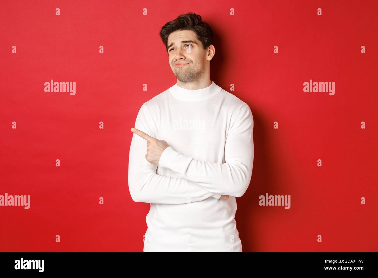 Concept of winter holidays. Image of displeased young man in white ...