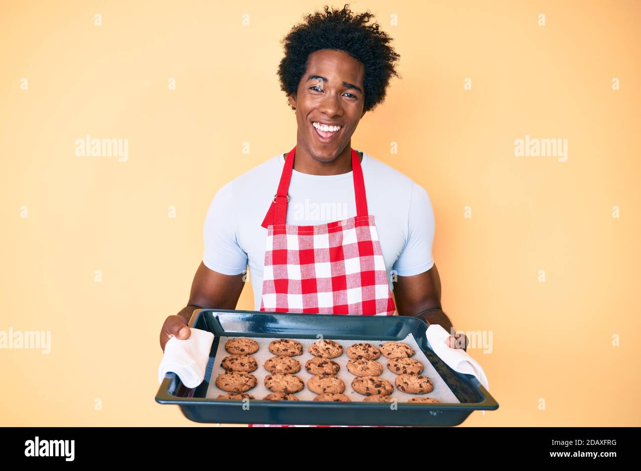 Handsome african american man with afro hair wearing baker uniform ...