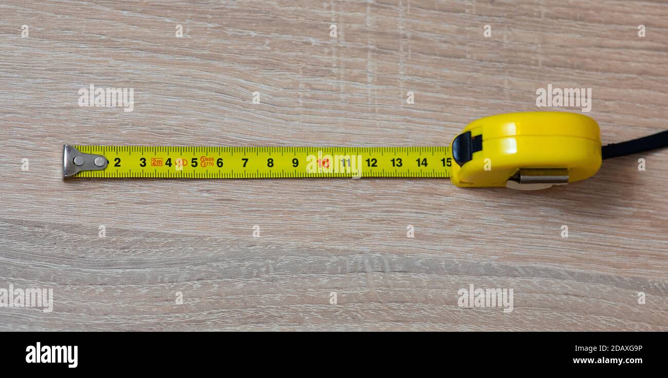 Tape measure on the table. Fifteen inches on a tape measure. The entire ...