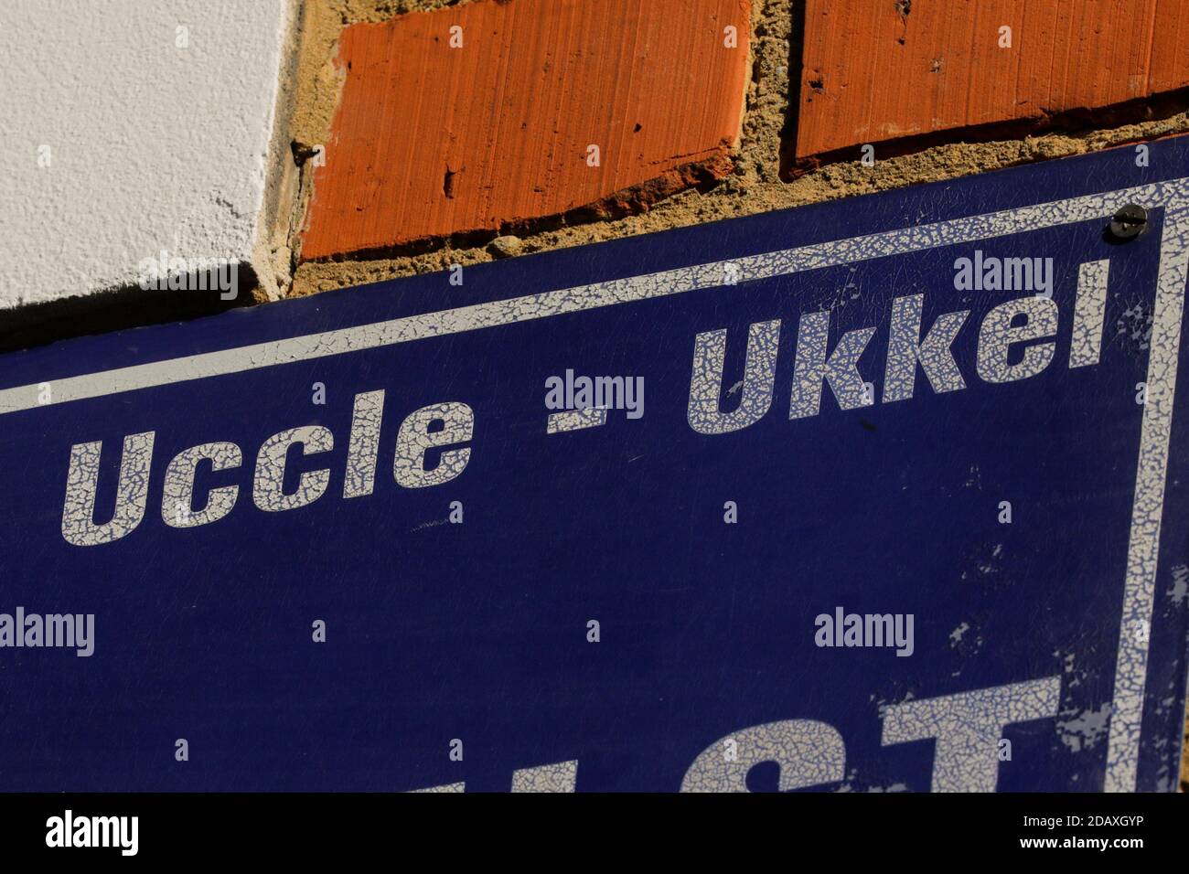 Illustration shows the name of the Uccle Ukkel municipality on a road ...