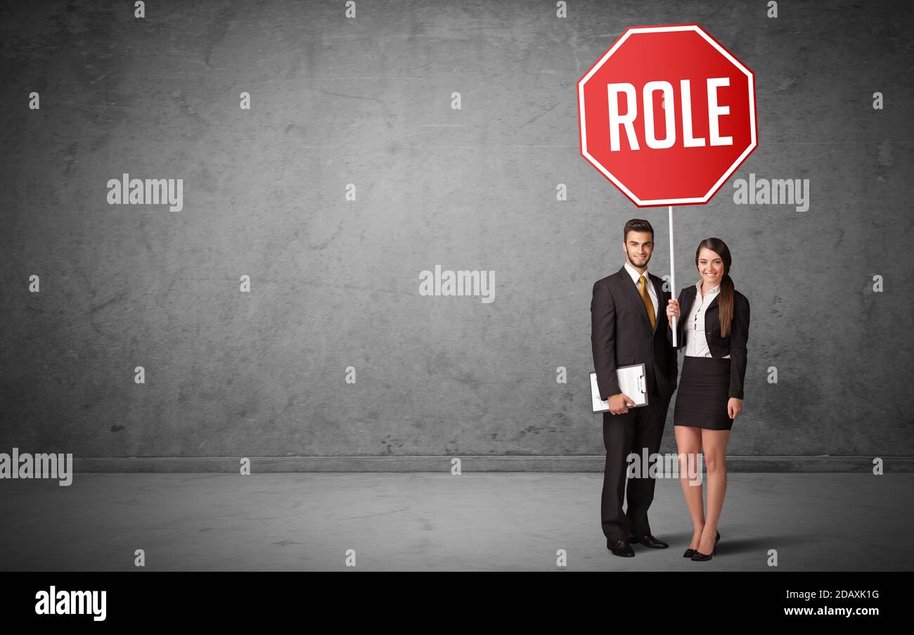 Young business person holding road sign with ROLE inscription, new ...