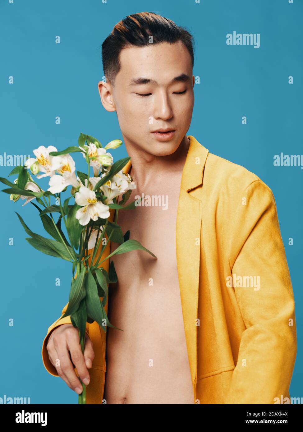 guy in a yellow coat asian appearance white flowers bouquet and side ...