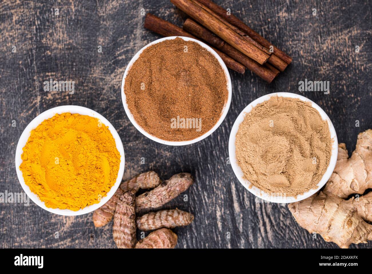 Powder of turmeric, cinnamon and ginger Stock Photo - Alamy