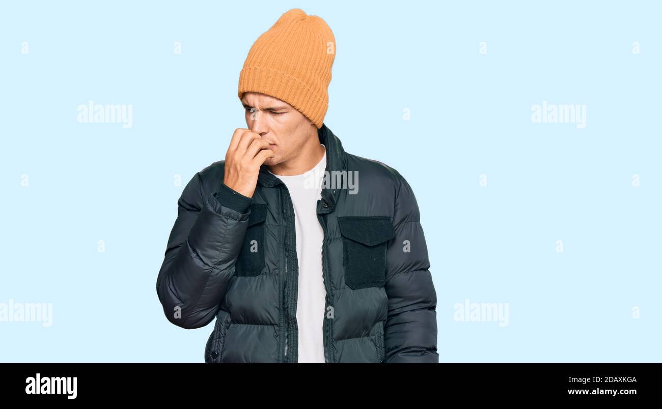 Handsome caucasian man wearing snow wear looking stressed and nervous ...